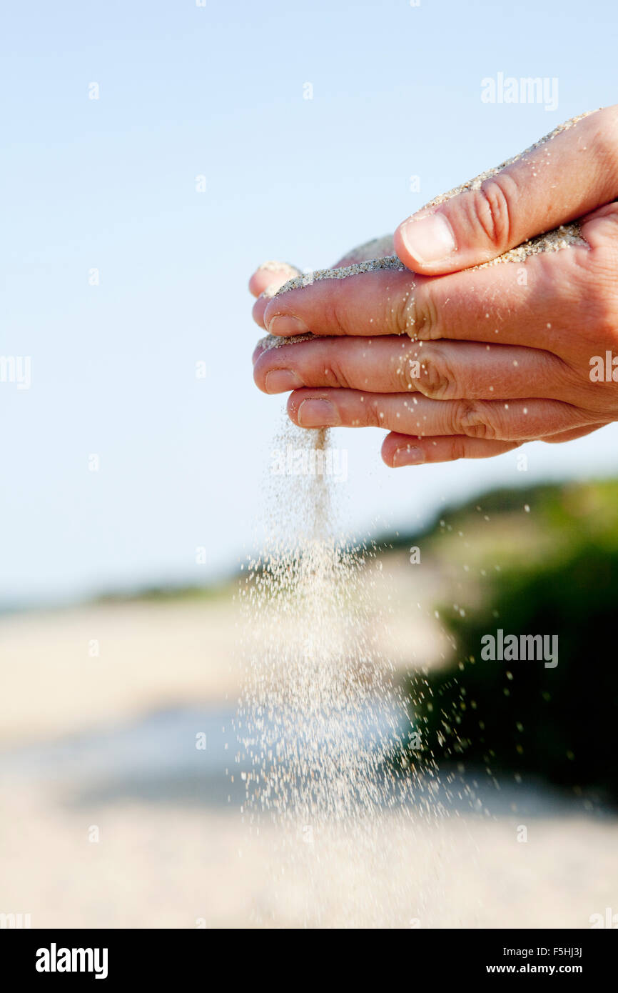 Sweden, Skane, Havang, Hands spilling sand Stock Photo - Alamy