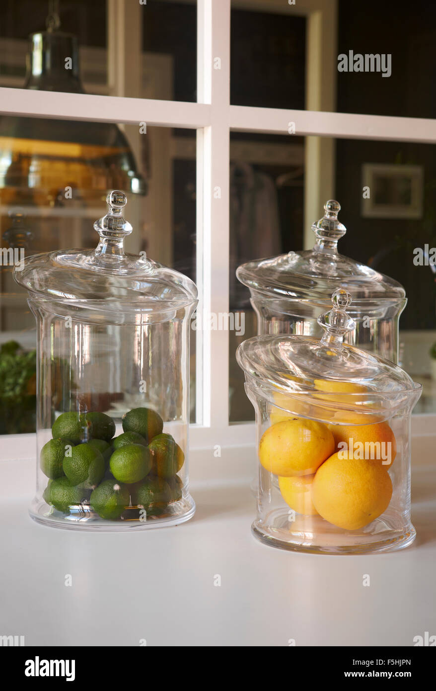 Three glass jars with fruits in a kitchen vertical Stock Photo - Alamy