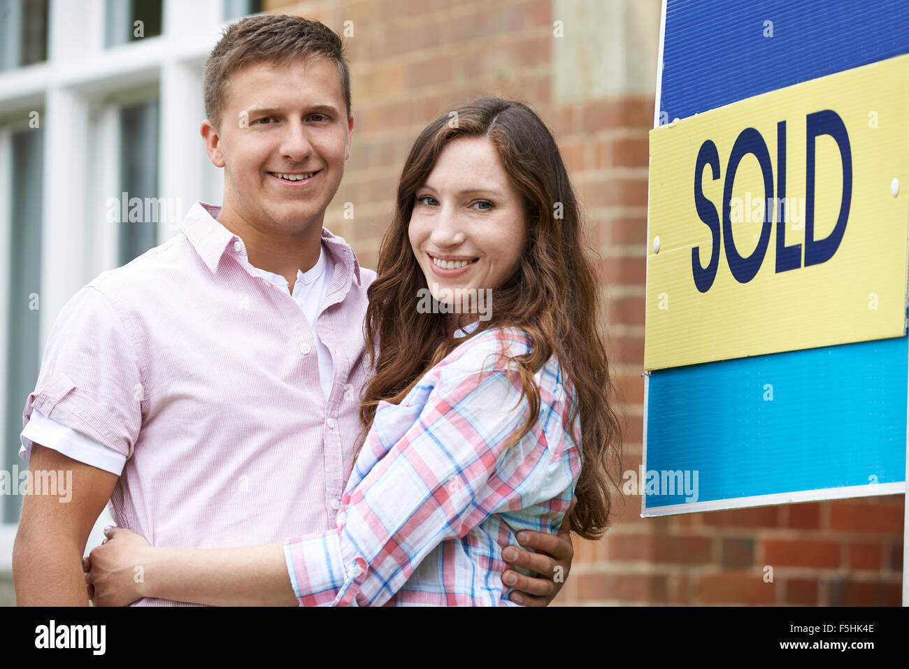 Excited Couple Outside New Home Together Stock Photo - Alamy