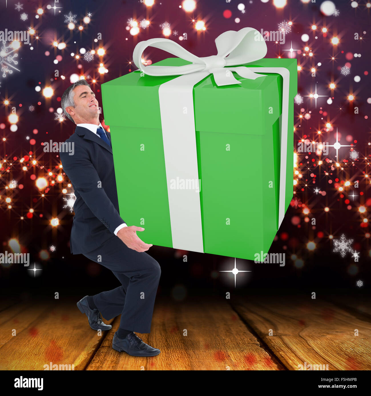 Composite image of stylish man with giant gift Stock Photo - Alamy