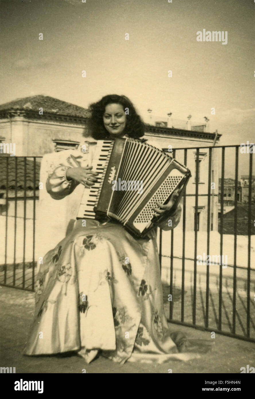 A woman playing the accordion , Italy Stock Photo - Alamy