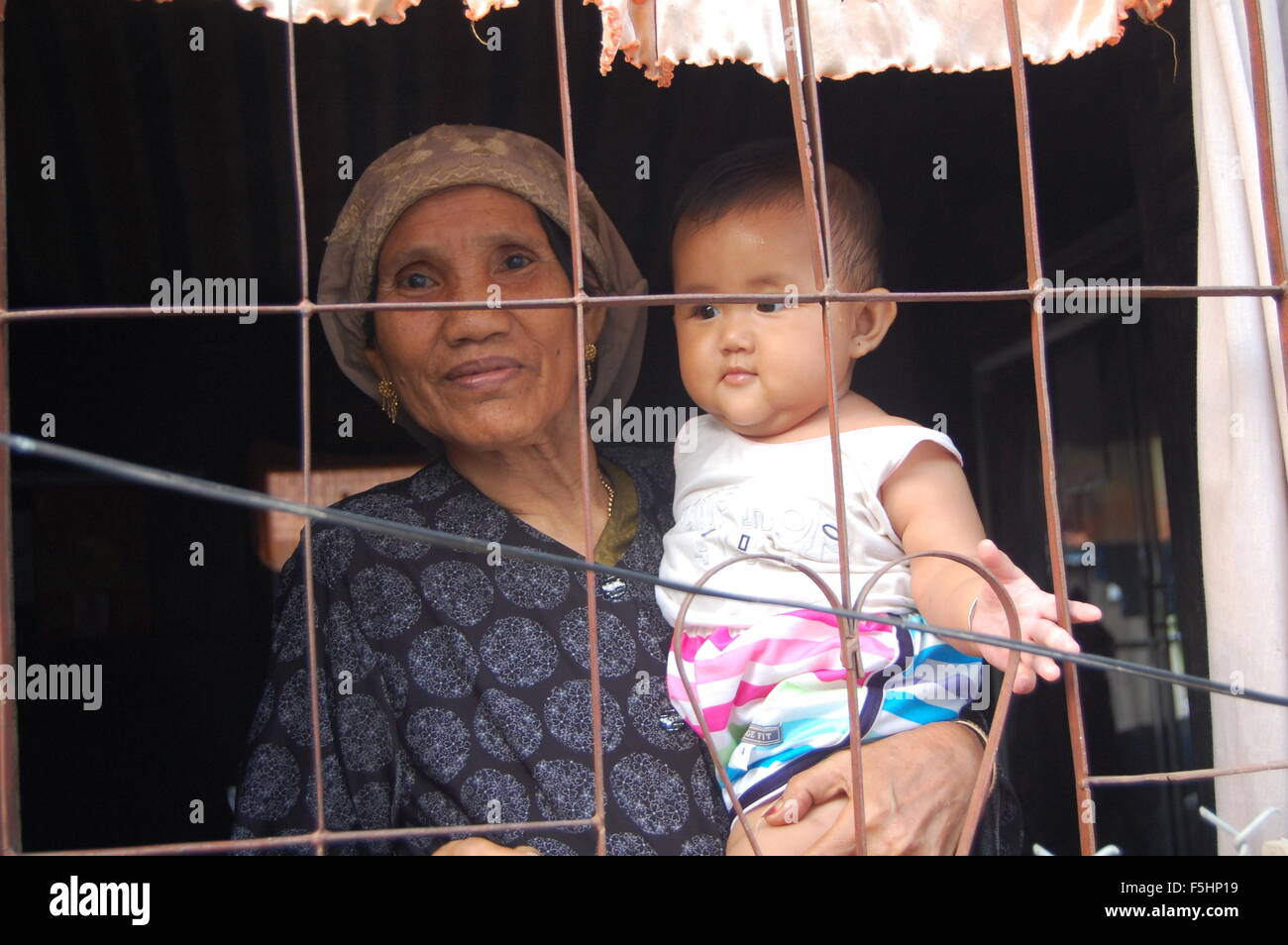 Old lady holding baby hi-res stock photography and images - Alamy