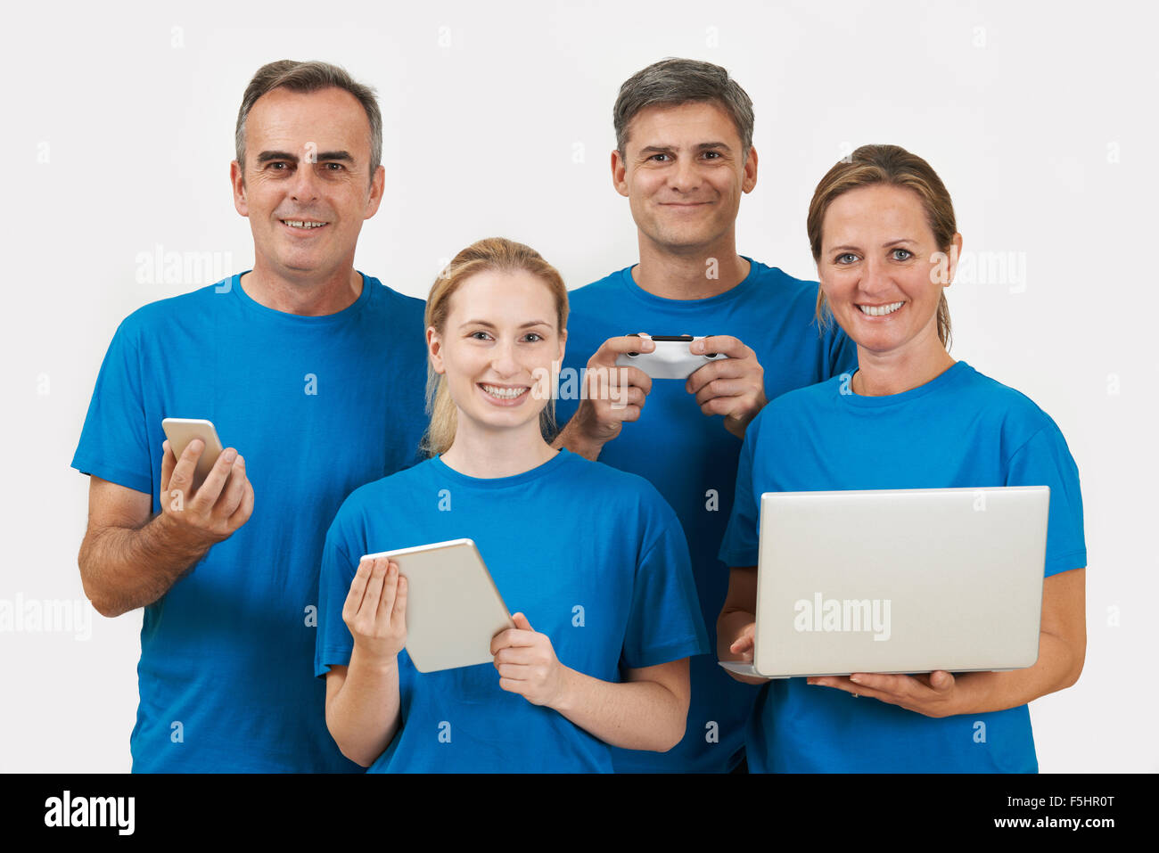 Studio Portrait Of IT Support Staff Wearing Uniform Against White ...