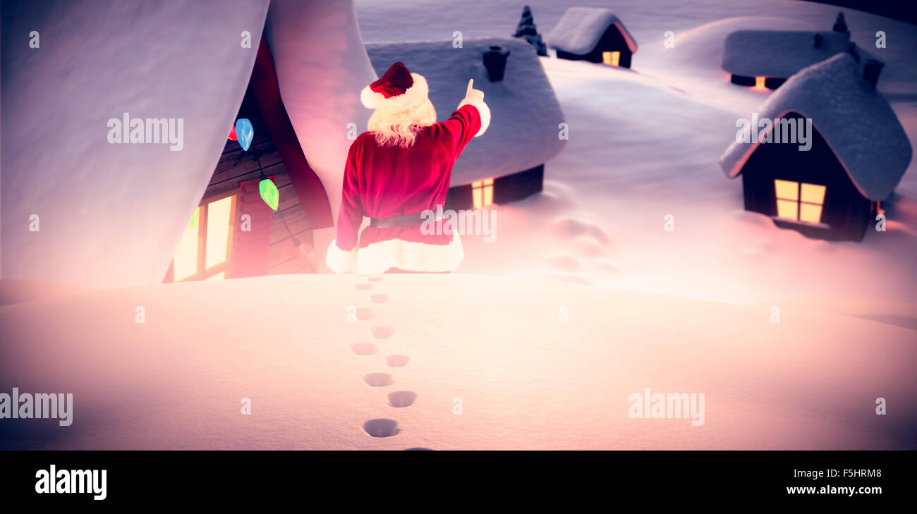 Composite image of santa claus points at something Stock Photo - Alamy