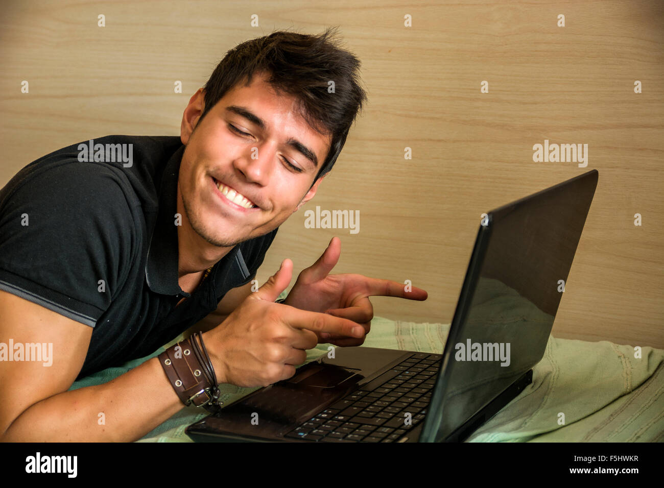 Young handsome man pointing gun hi-res stock photography and images - Alamy