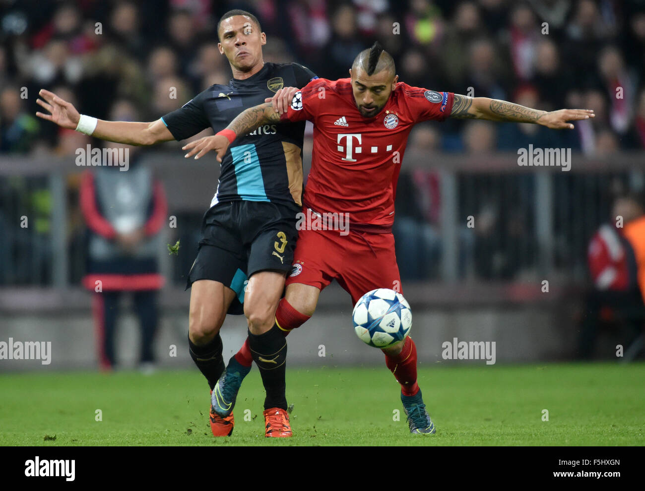 Munich's Arturo Vidal (R) against Arsenal's Kieran Gibbs during the ...