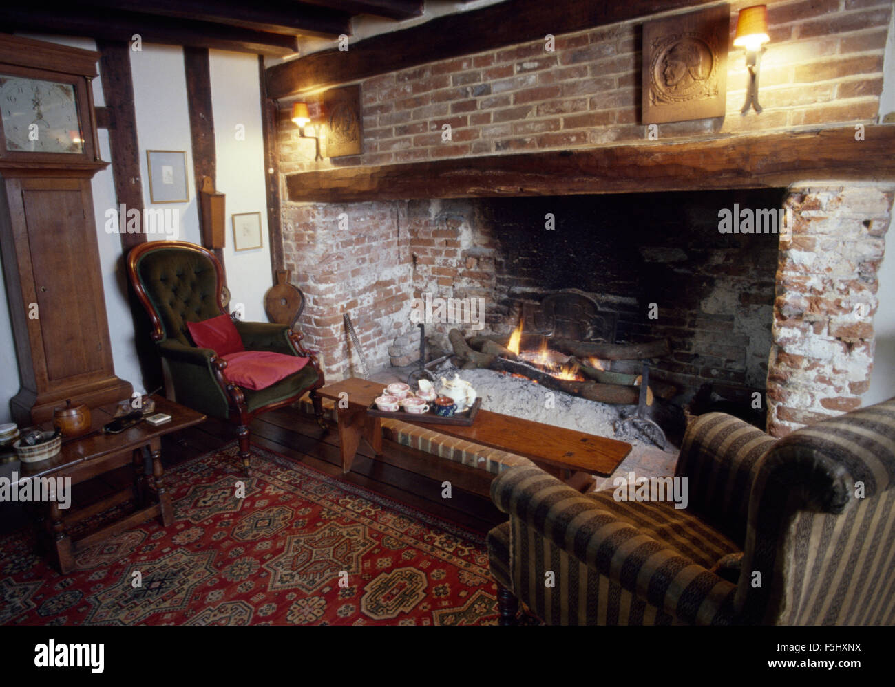 Victorian button-back chair and velvet armchair either side of ...