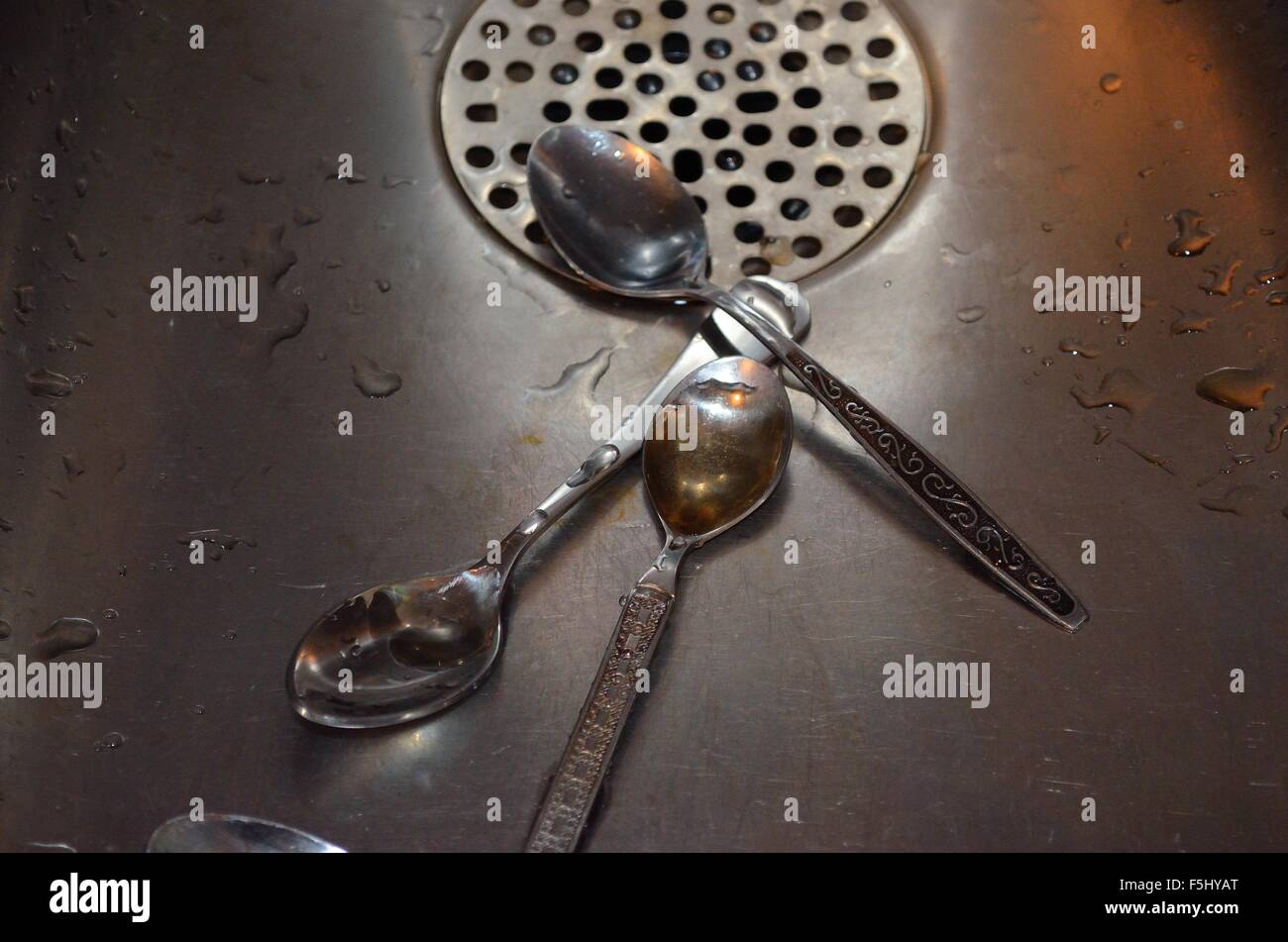 cutlery, knife and spoon in sink Stock Photo - Alamy