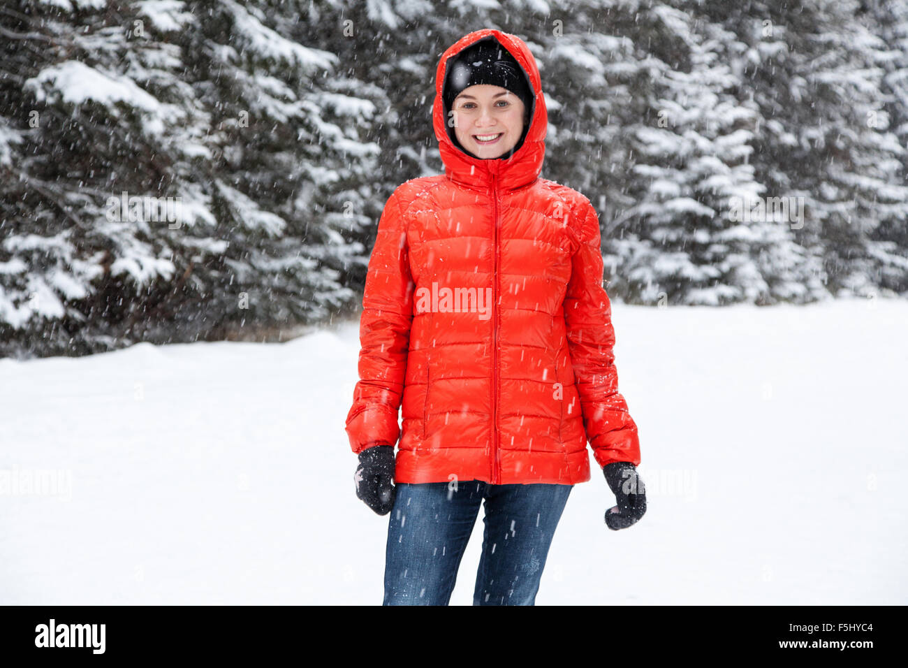 Pretty young woman playing snowballs Stock Photo - Alamy
