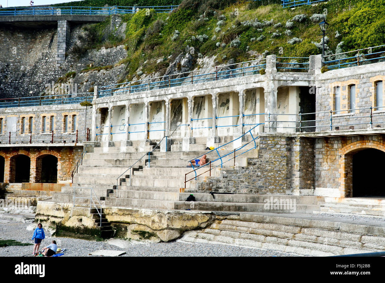 People relaxing and sunbathing on the steps of the old Victorian ...
