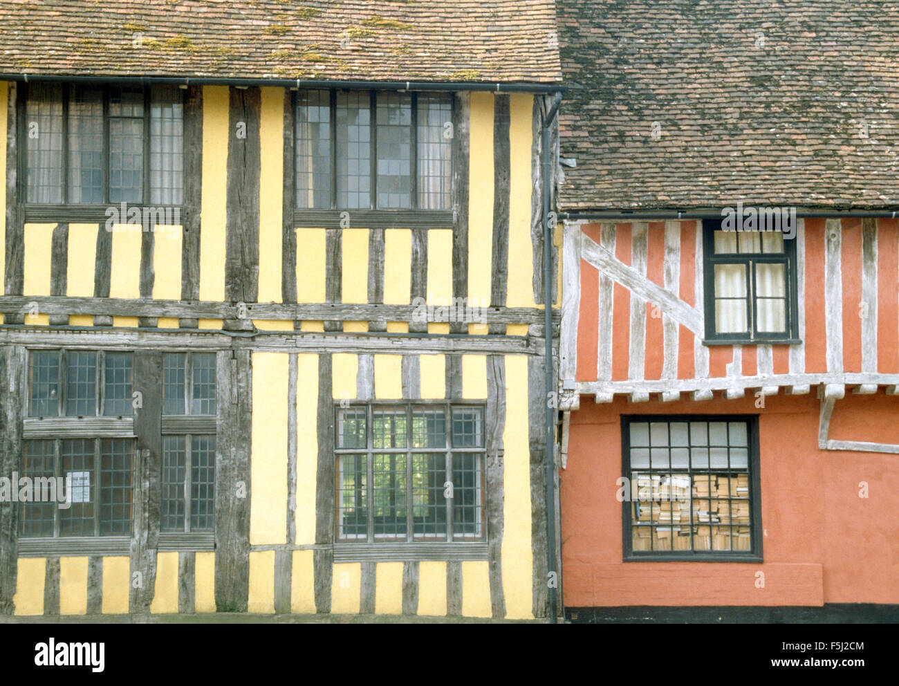 Exterior of yellow and terracotta timbered medieval houses in Suffolk ...