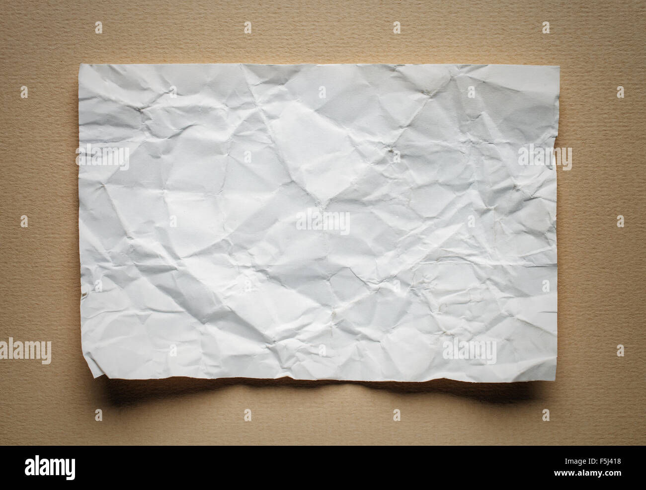 Crumpled white paper card on beige background, place for text Stock ...