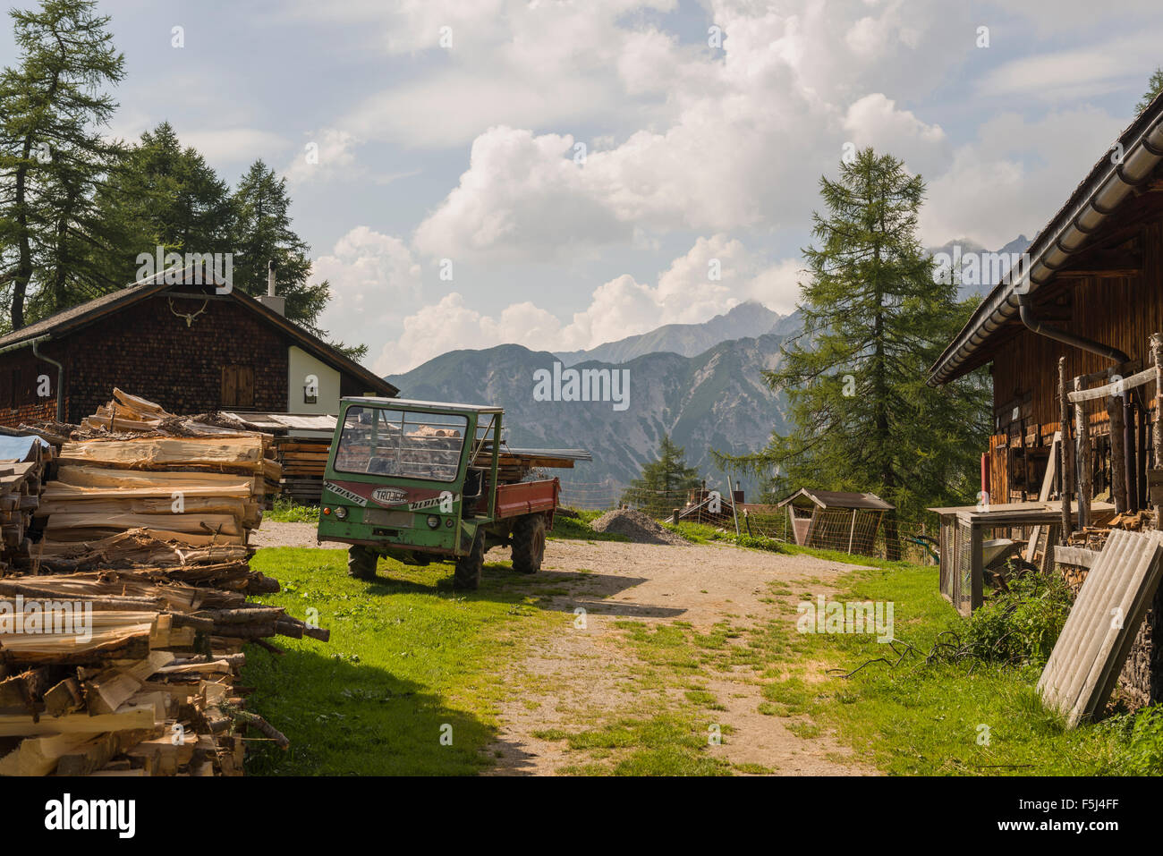 Austrian farm at the top of a mountain with a little cargo vehicle ...