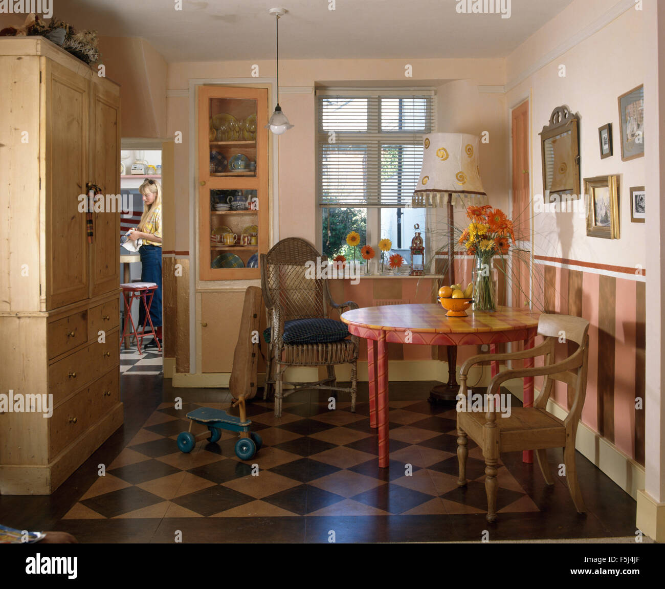 Painted chequer-board flooring and painted pink table in nineties ...