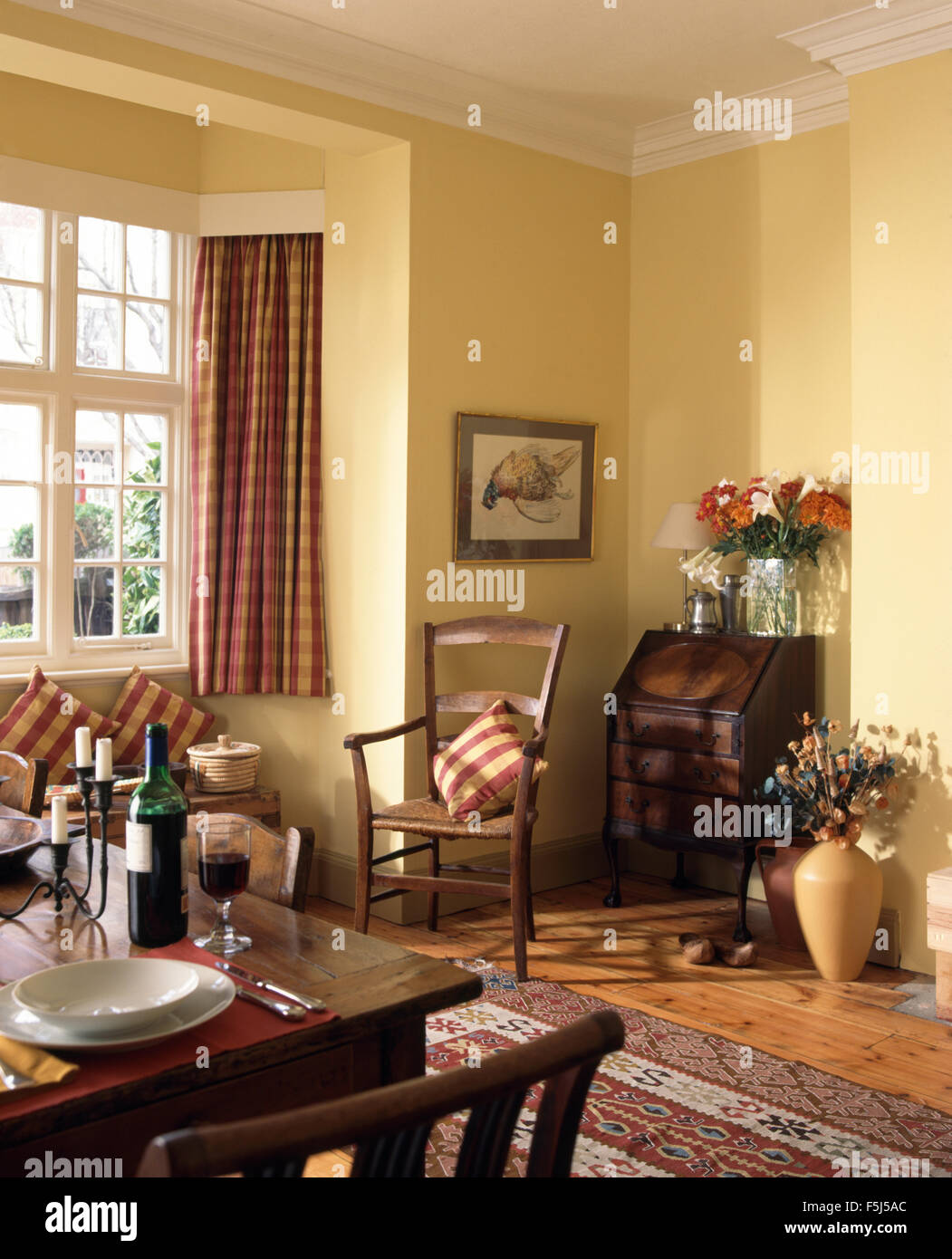 Table set for lunch in a pale yellow nineties dining room with an ...