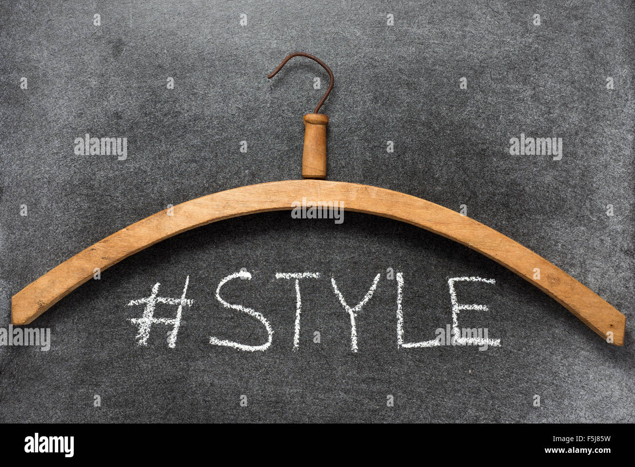 hashtag style sign handwritten on blackboard with vintage wooden hanger ...