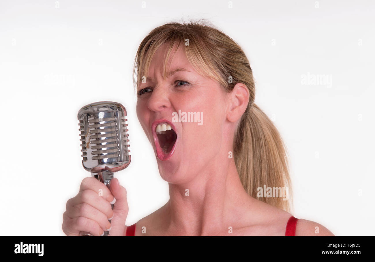 Woman speaking into microphone hi-res stock photography and images - Alamy