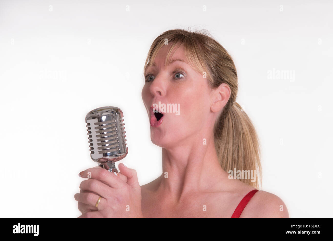 Singer using microphone hi-res stock photography and images - Alamy