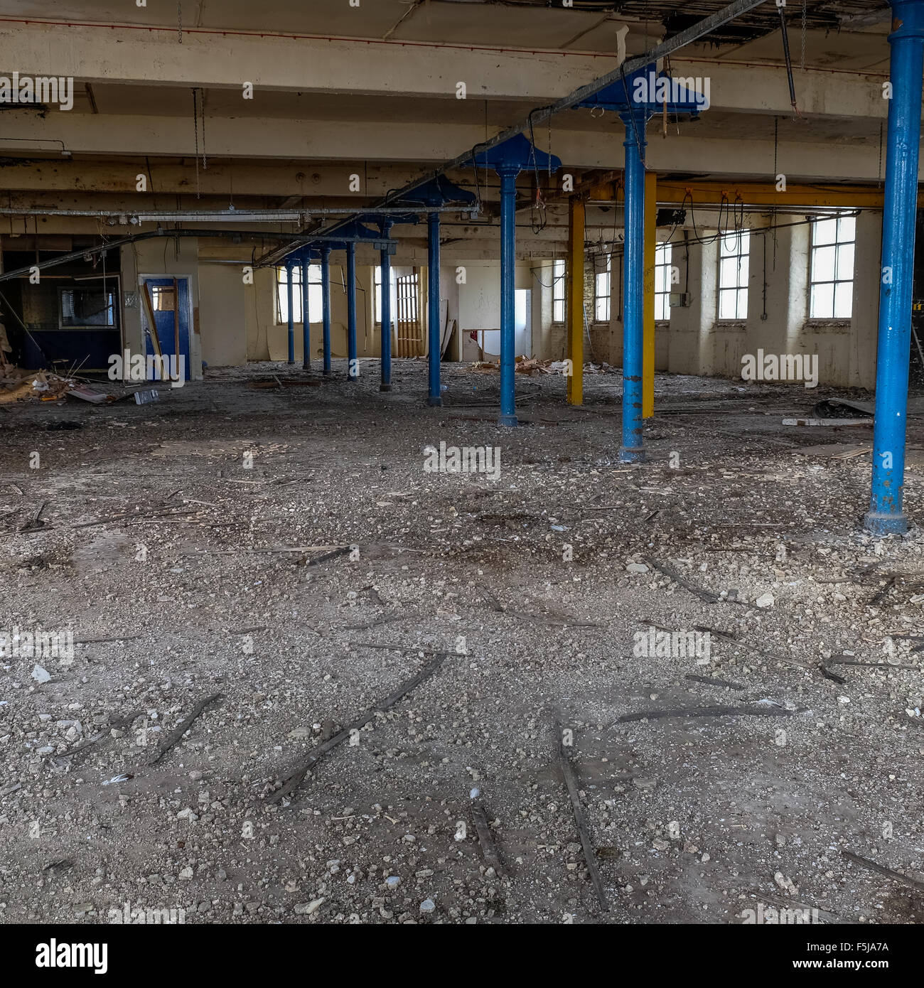Derelict empty warehouse with debris on the floor Stock Photo - Alamy