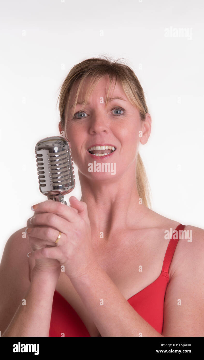 Woman speaking into microphone hi-res stock photography and images - Alamy
