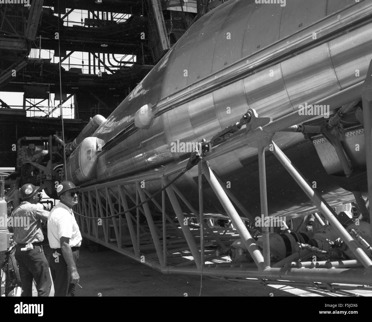 Photograph detailing the attachment of hoist cables to Atlas missile ...