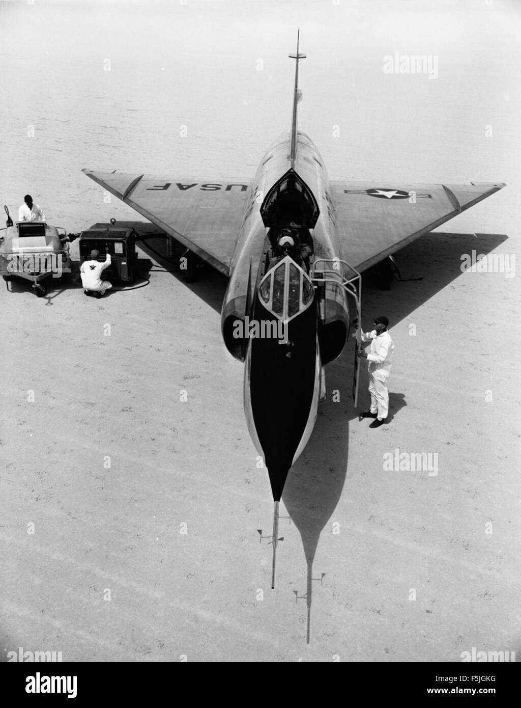 A photograph of Convair YF-102A 52-7995, with company employees ...