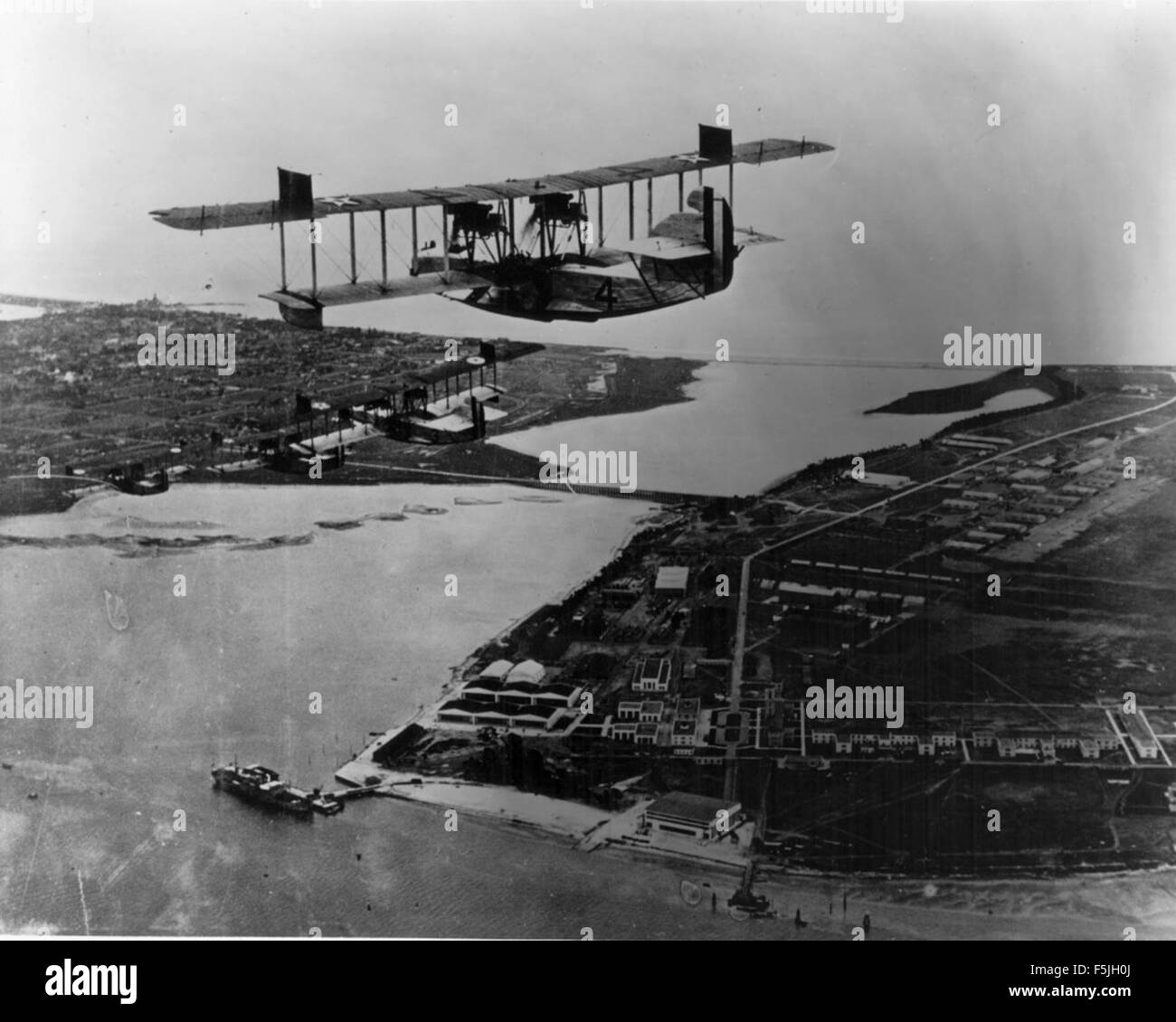 A 1920s photograph showing a U.S. Navy F5L seaplane flying over San ...