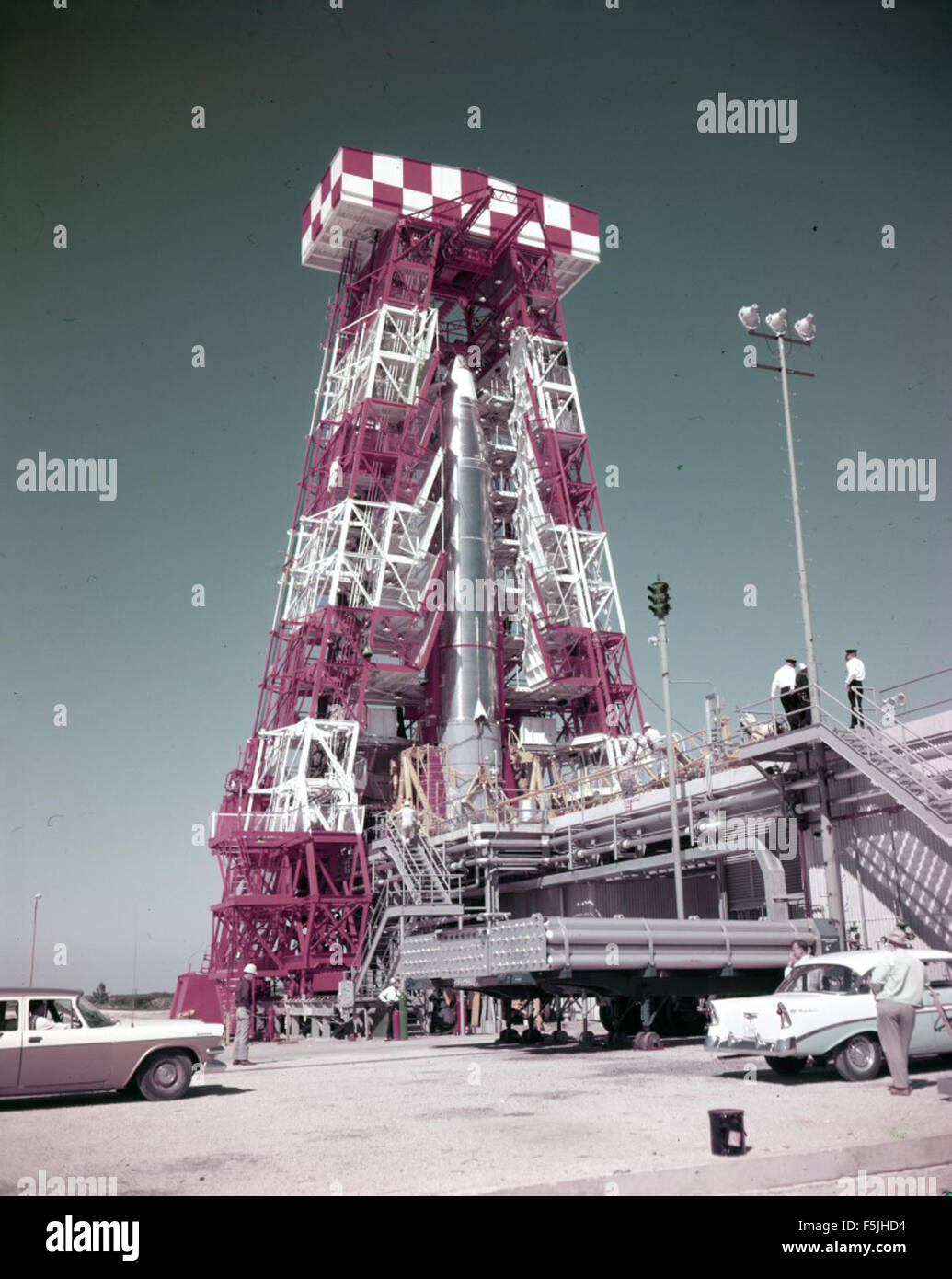 The image shows the Atlas 4A missile being erected into its service ...