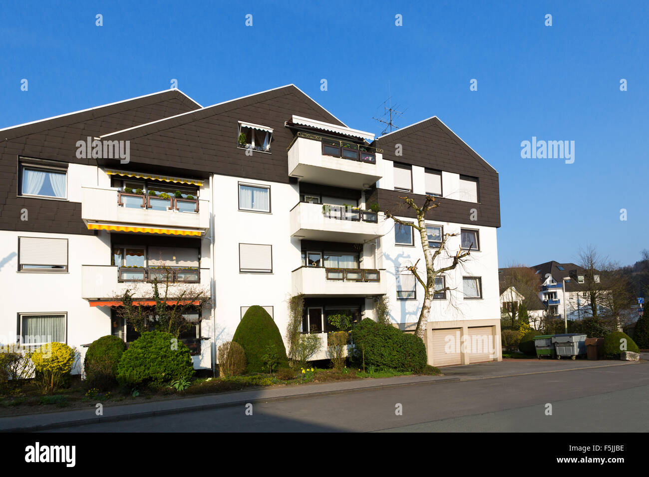 European suburban multiapartment house against blue sky Stock Photo - Alamy