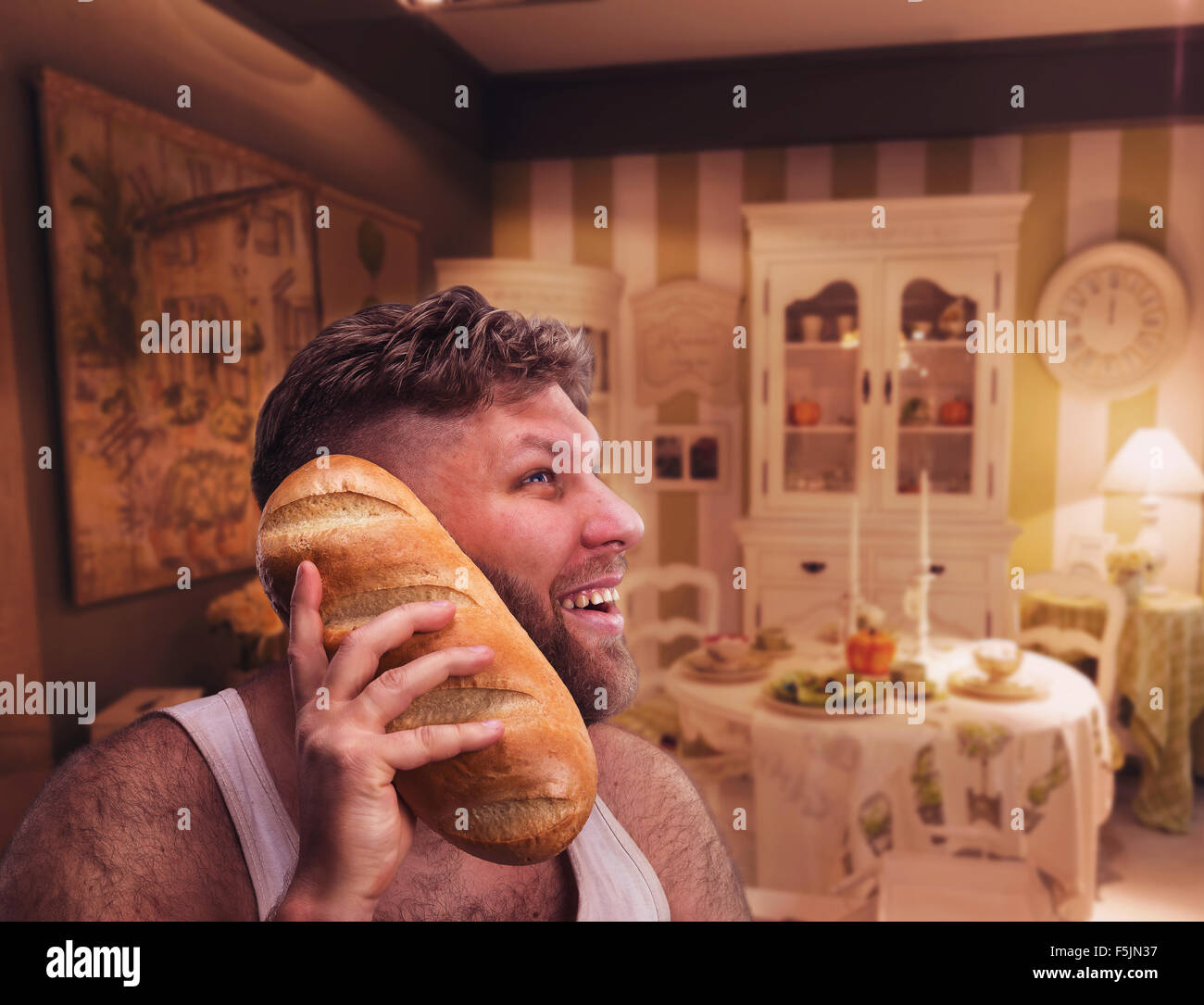 Strange happy man listening to something in bread in home interior ...