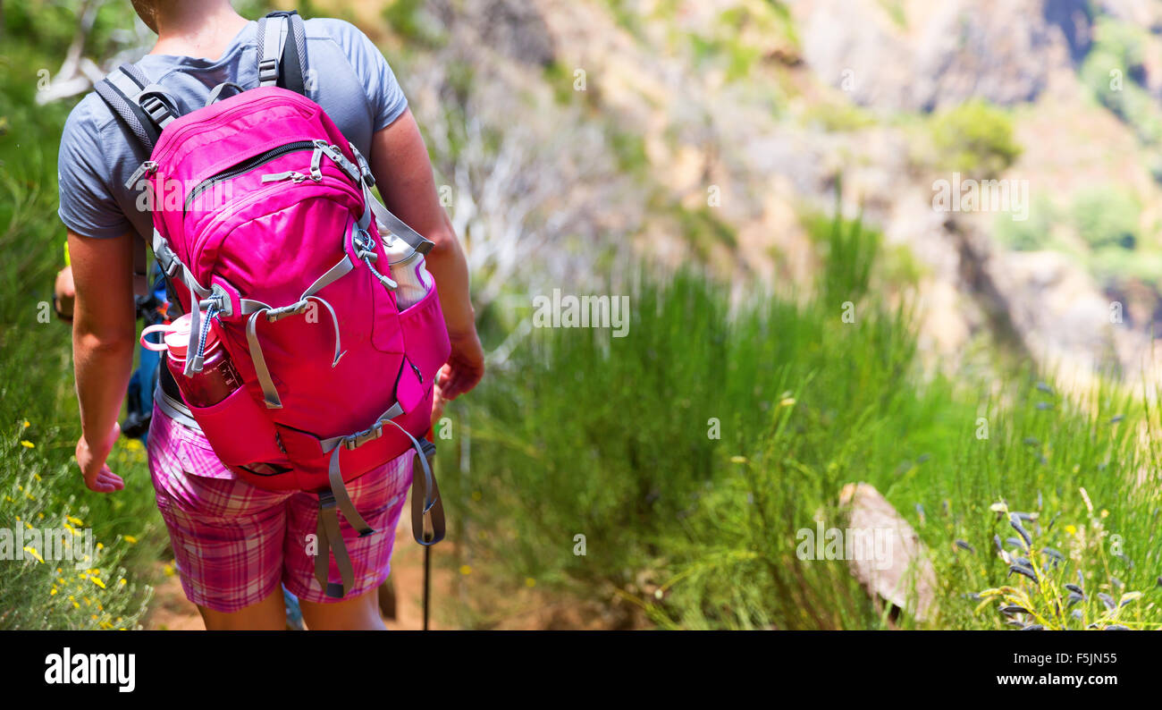 Woman with a pink backpack hiking in mountains, Portugal, Madeira Stock ...