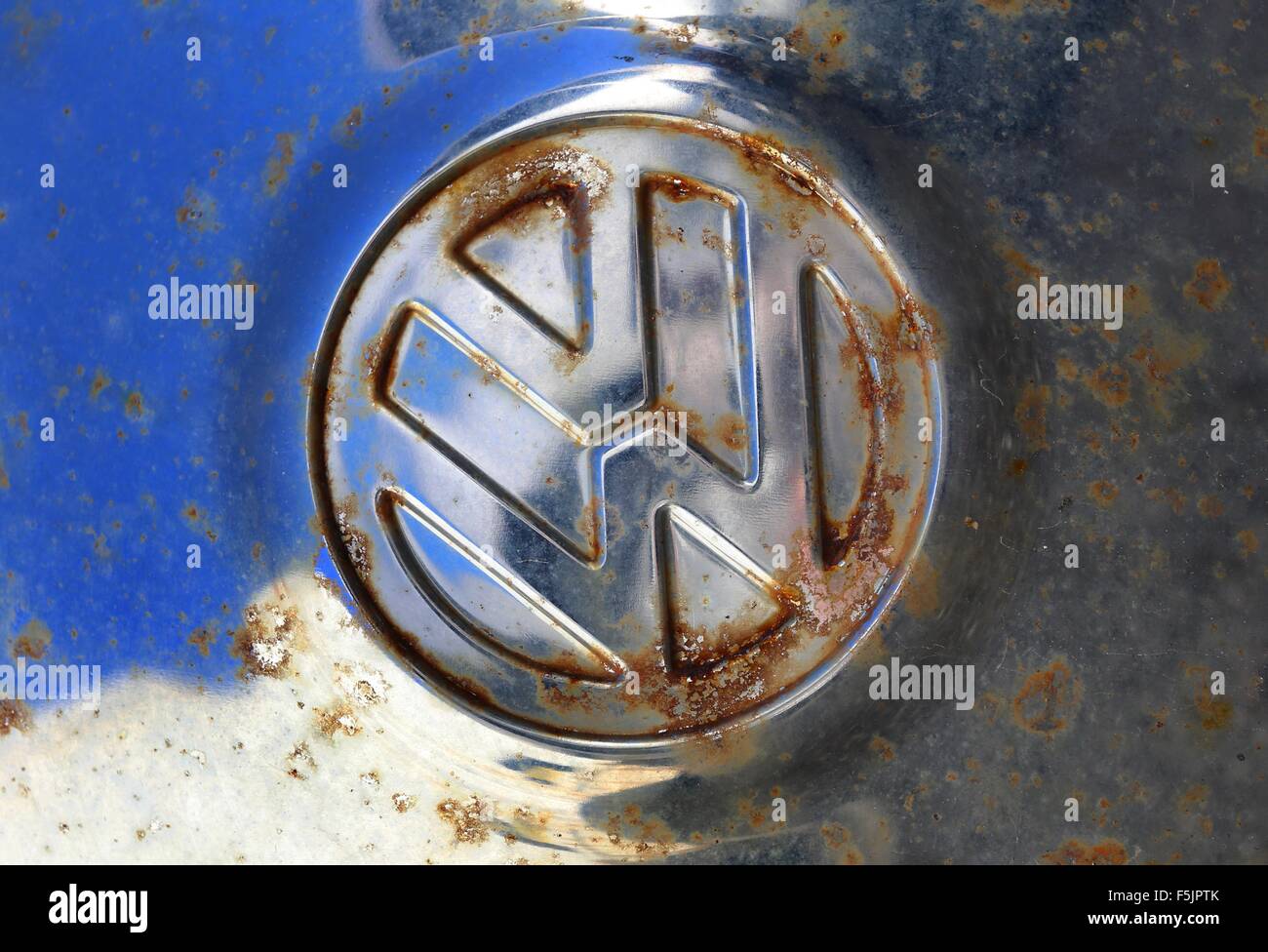 A rusty VW Logo on the hubcap of an old VW Beetle at a garage in ...