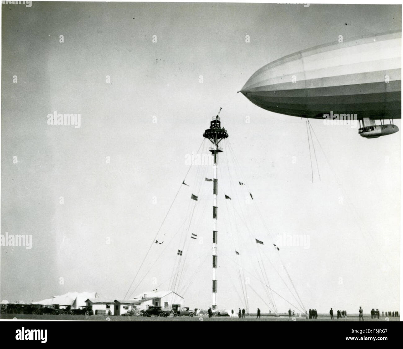 A historical photograph of the USS Shenandoah, a rigid airship, docked ...