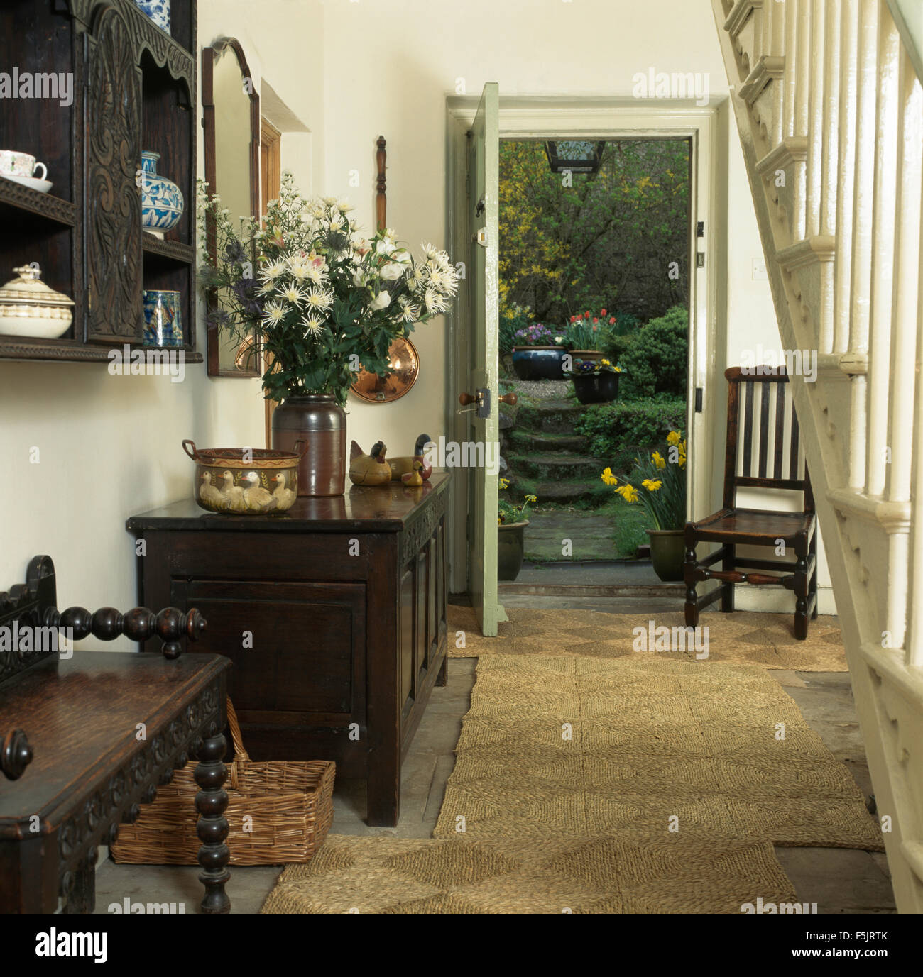 Oak chest and rush matting in nineties country hall Stock Photo - Alamy