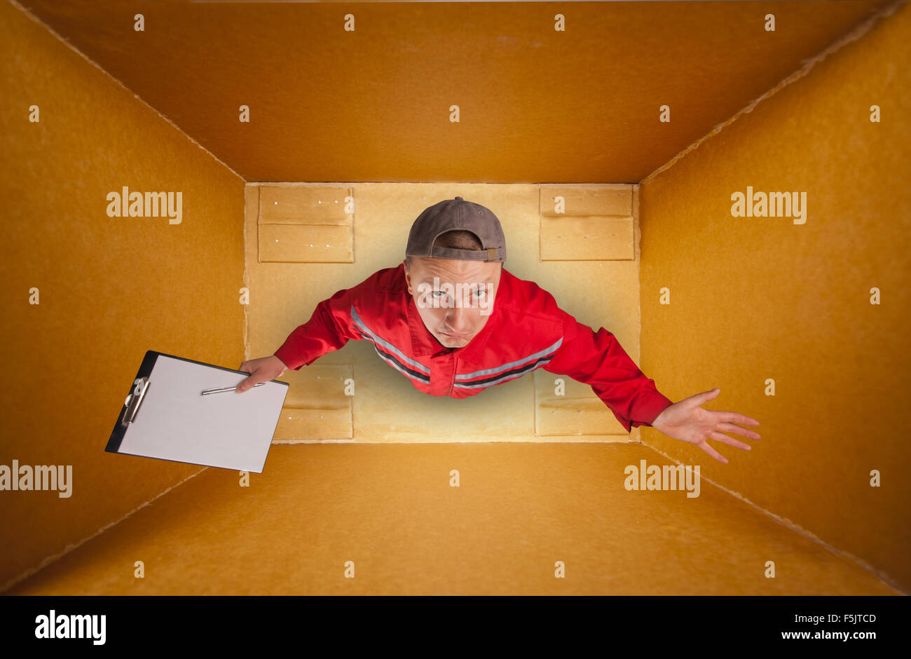 Sad mail courier with clipboard inside empty box Stock Photo - Alamy