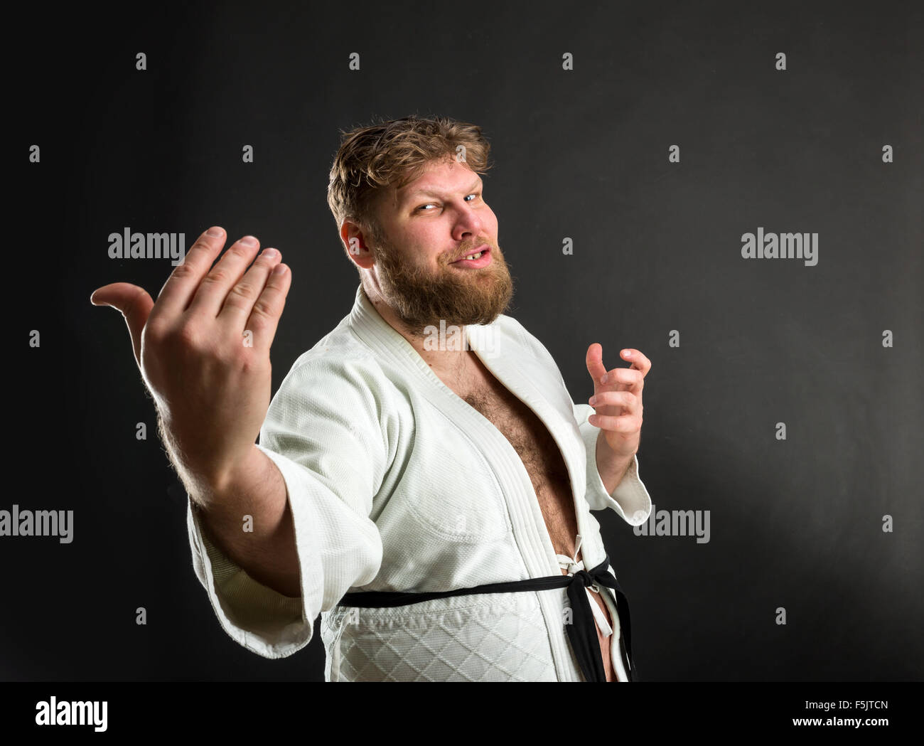 Bearded karate fighter in white kimono calls you to fight Stock Photo ...