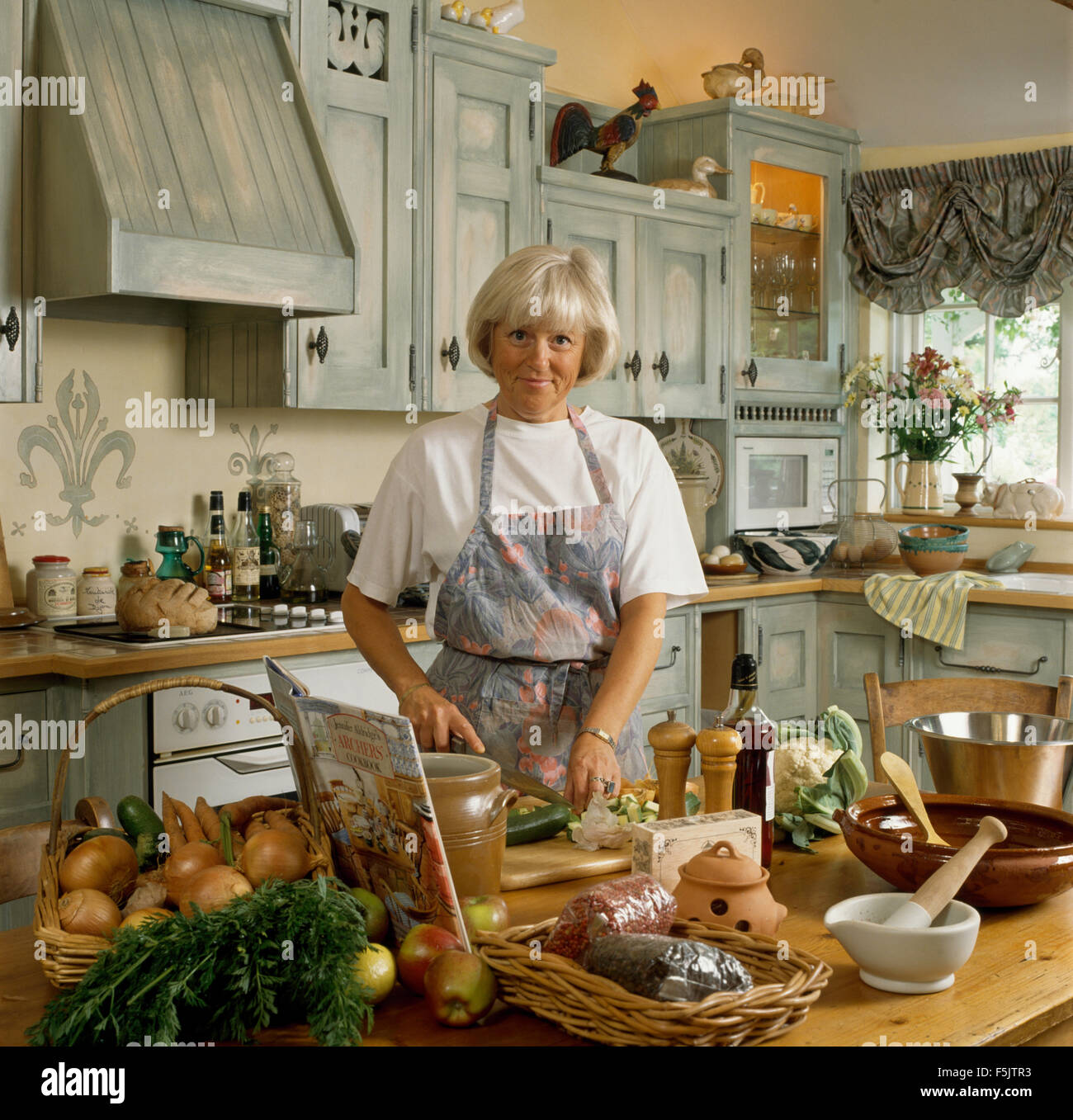 Portrait of a woman cooking in her kitchen FOR EDITORIAL USE ONLY Stock ...