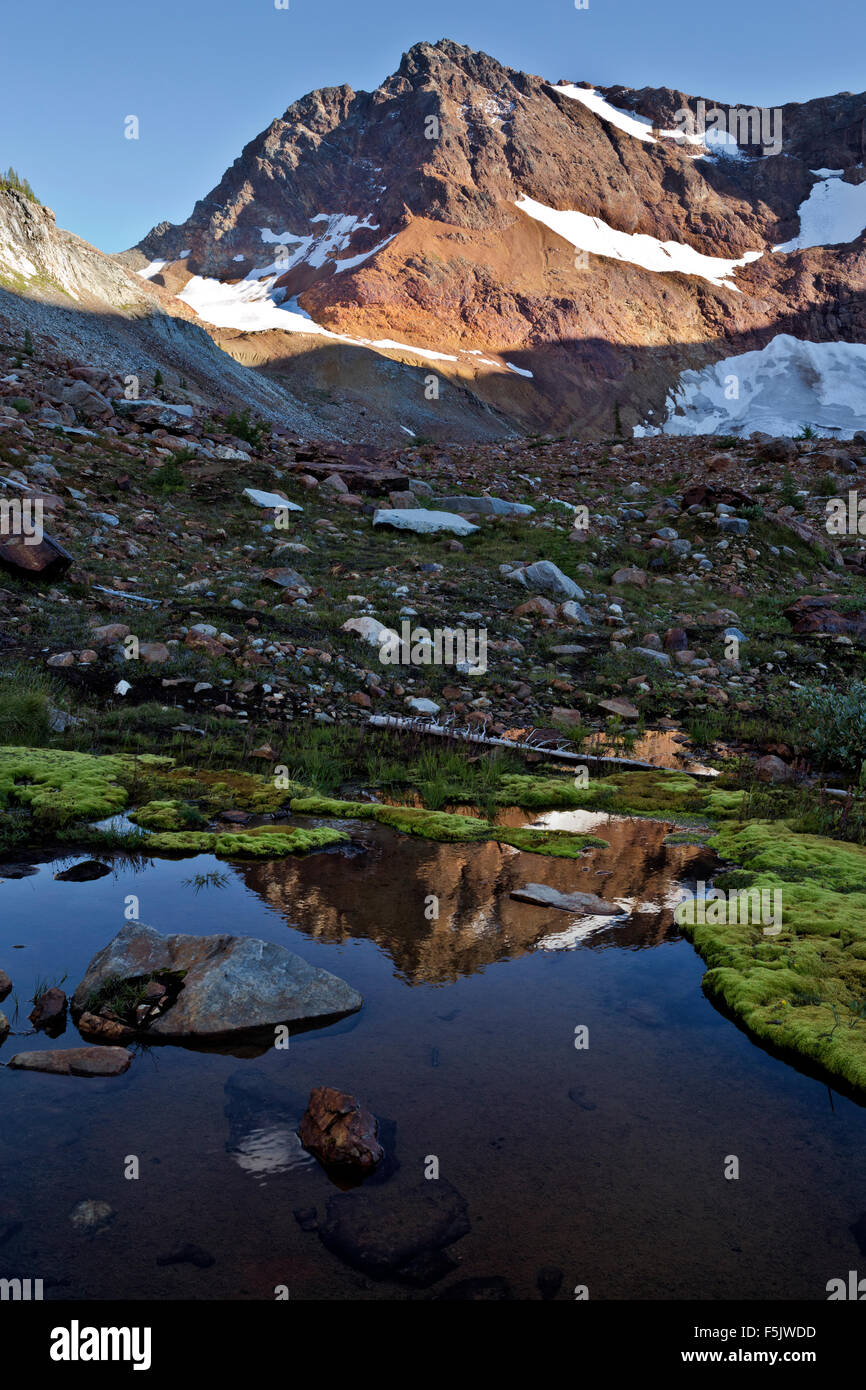 WASHINGTON - Red Mountain reflecting in a small tarn in Upper Lyman ...