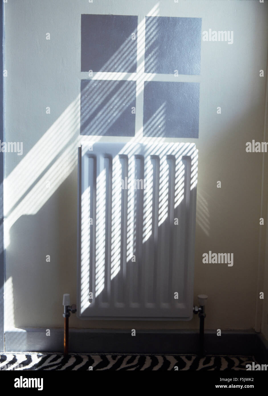 Sun slanting on to white radiator in a nineties hall Stock Photo - Alamy