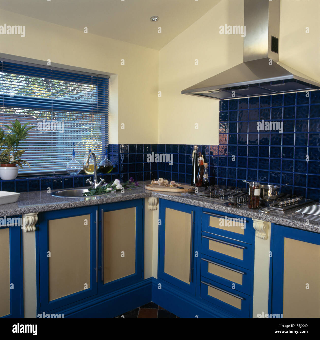 Stainless steel extractor above hob in a small economy style nineties ...