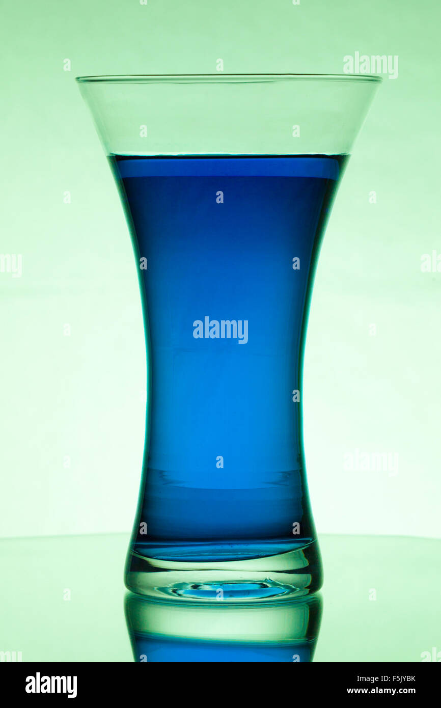 1 glass containing coloured liquid against a coloured background Stock ...