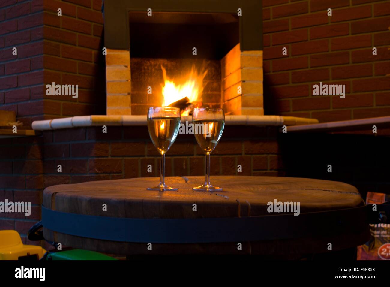 A relaxing evening - glass of wine fireside Stock Photo - Alamy
