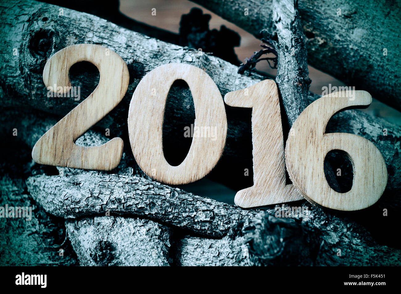 wooden numbers forming the number 2016, as the new year, with a pile of ...
