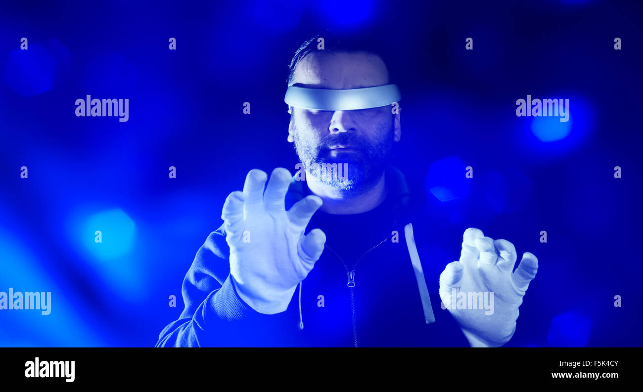 Computer hacker typing on virtual reality touch panel, blue abstract ...