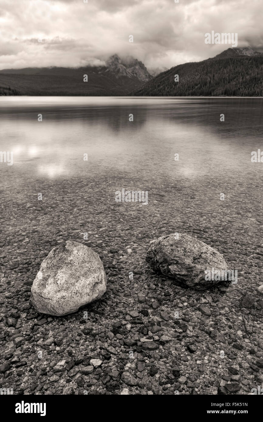 A B&W of two boulders in the shallow Redfish Lake with the Sawtooth ...