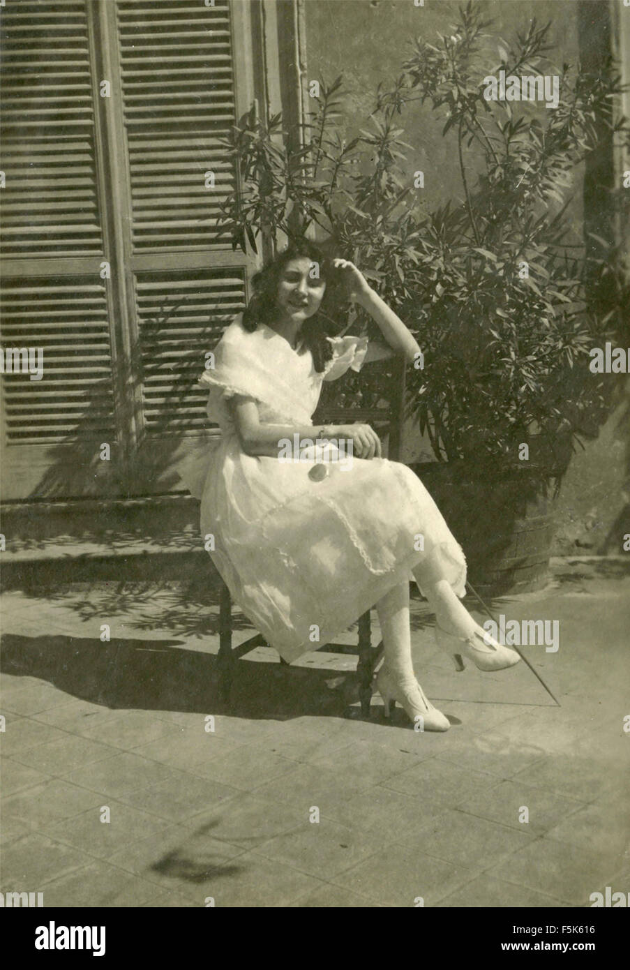 Woman sitting on a chair, Italy Stock Photo - Alamy