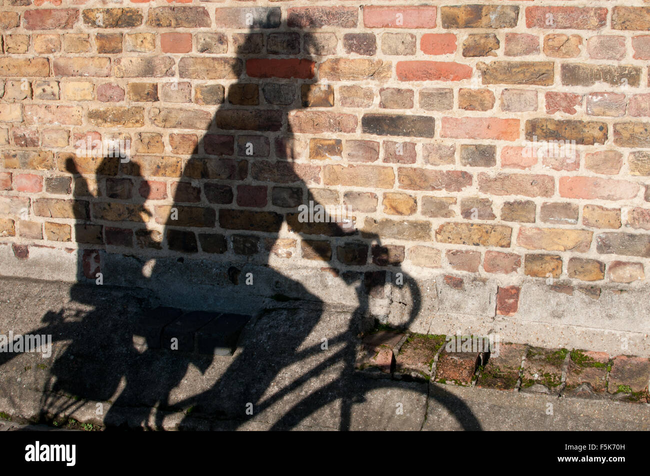 man and baby on bike shadow Stock Photo - Alamy