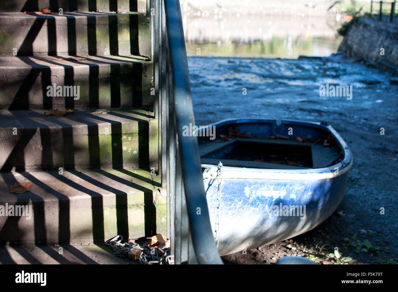 boat on riverbank and staircase with shadows Stock Photo - Alamy