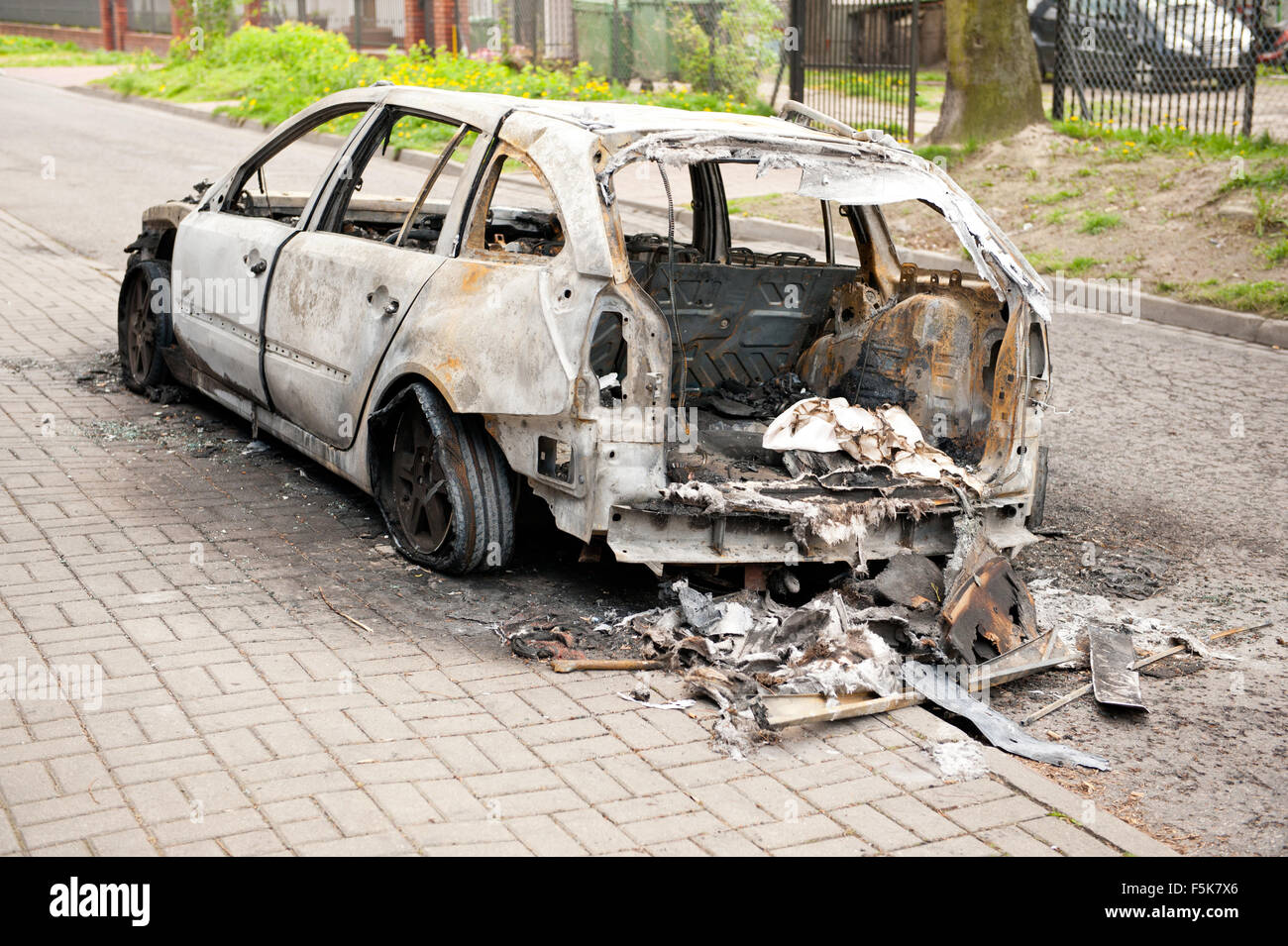 Burnt car back in arson fire, white car wreck at the pavement in Poland ...