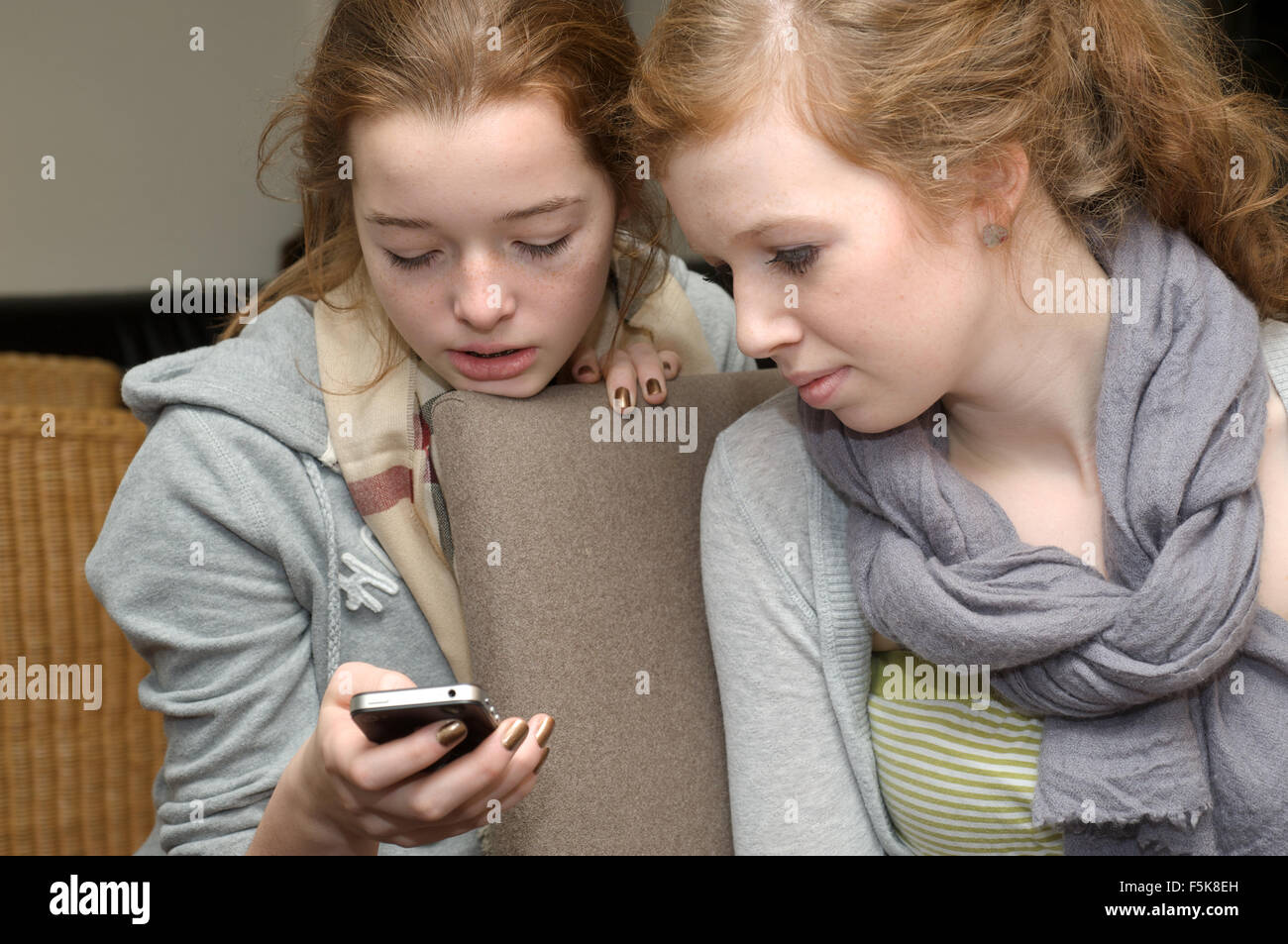 Teenage girls reading texts on a mobile phone Stock Photo - Alamy